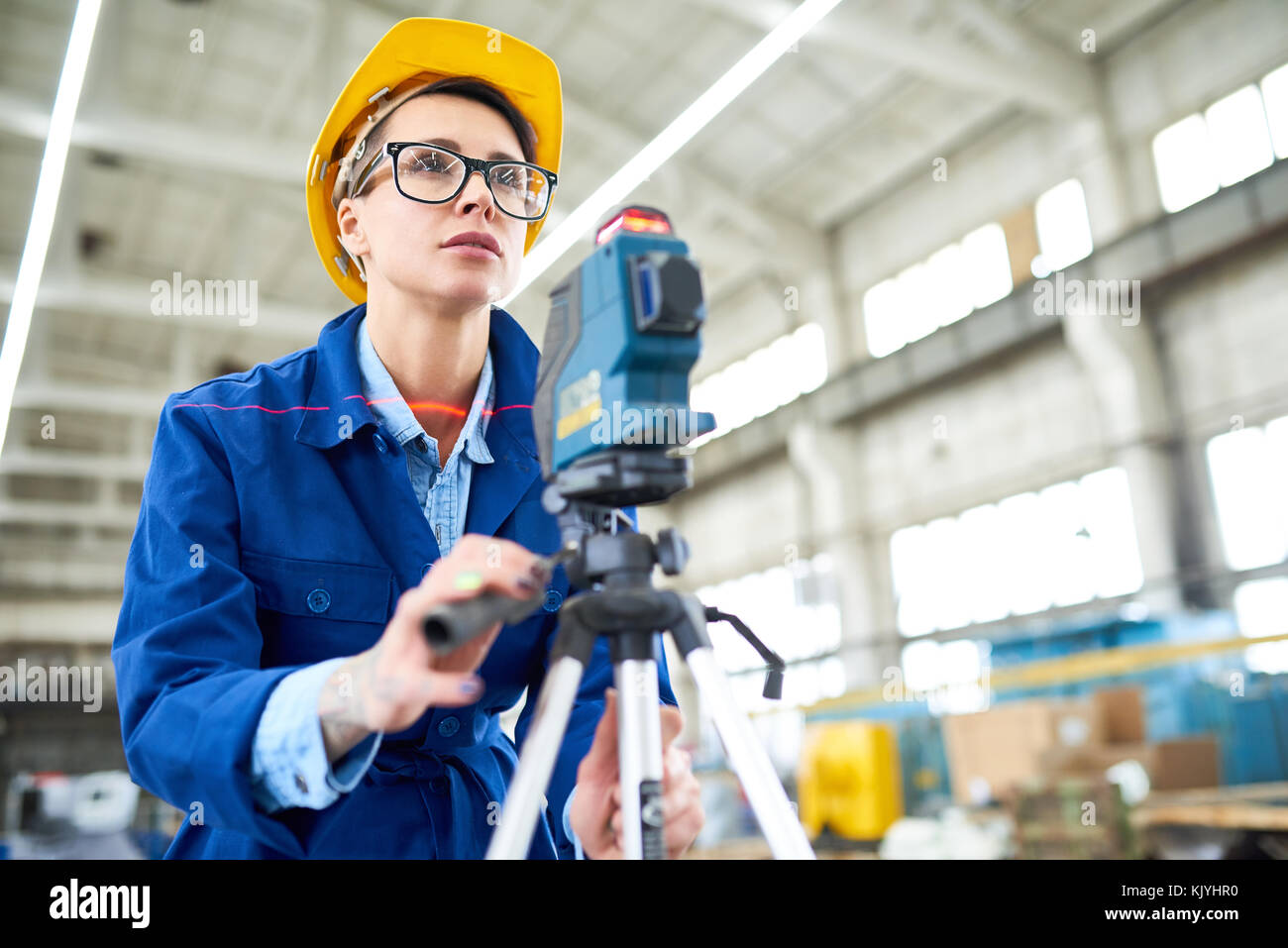 Serious concentrated female engineer focusing on survey line while ...