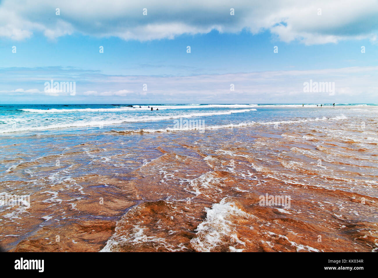 Shallow water on the sandy sea beach. Appears through sand, in the ...