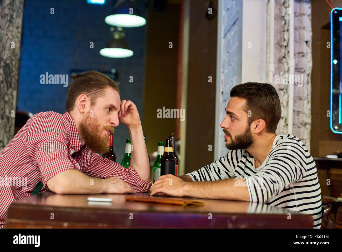 Two Men Sitting At Table At Bar Stock Photos & Two Men Sitting At Table ...