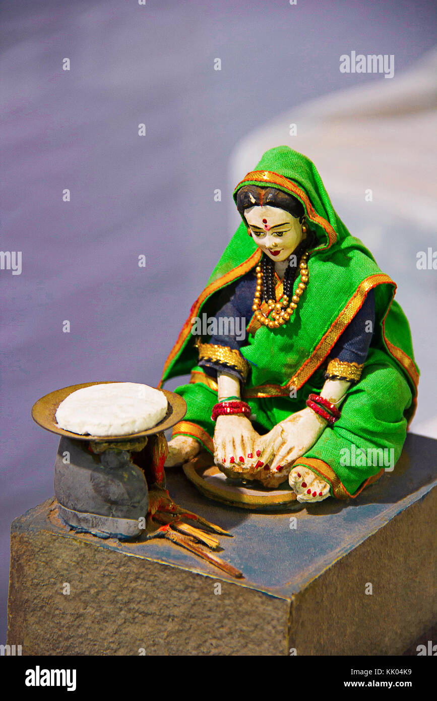 Sculpture of traditional Maharashtrian woman making rotis on a ...