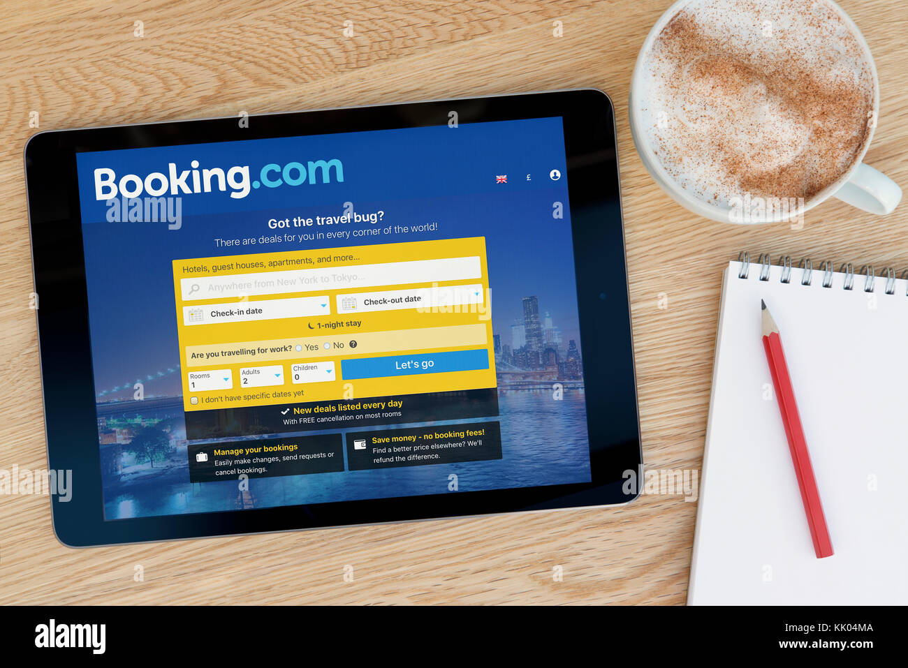 A man looks at the Booking.com website on his iPad tablet device, shot ...