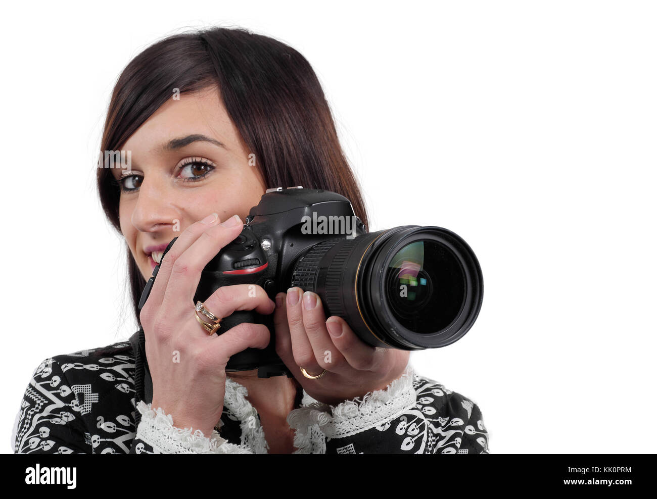 young brunette woman holding slr camera isolated on white background ...