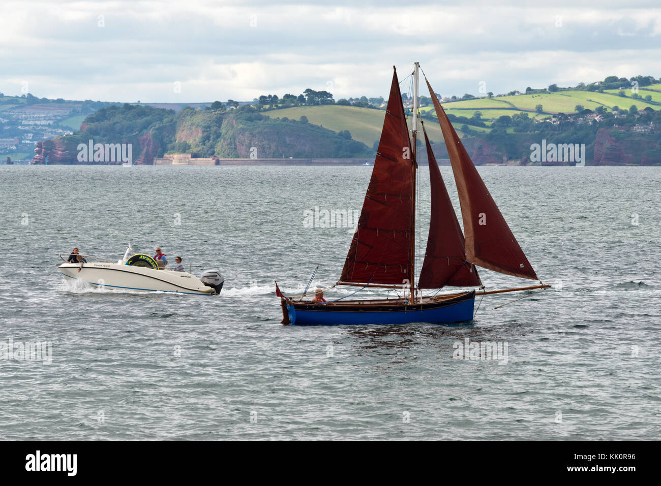 A lone yachtsman sailing into the entrance of the River Exe at Exmouth ...
