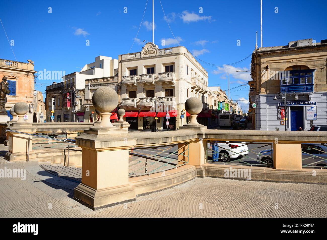 Steps leading to the Mosta Dome with buildings around Rotunda Square in ...
