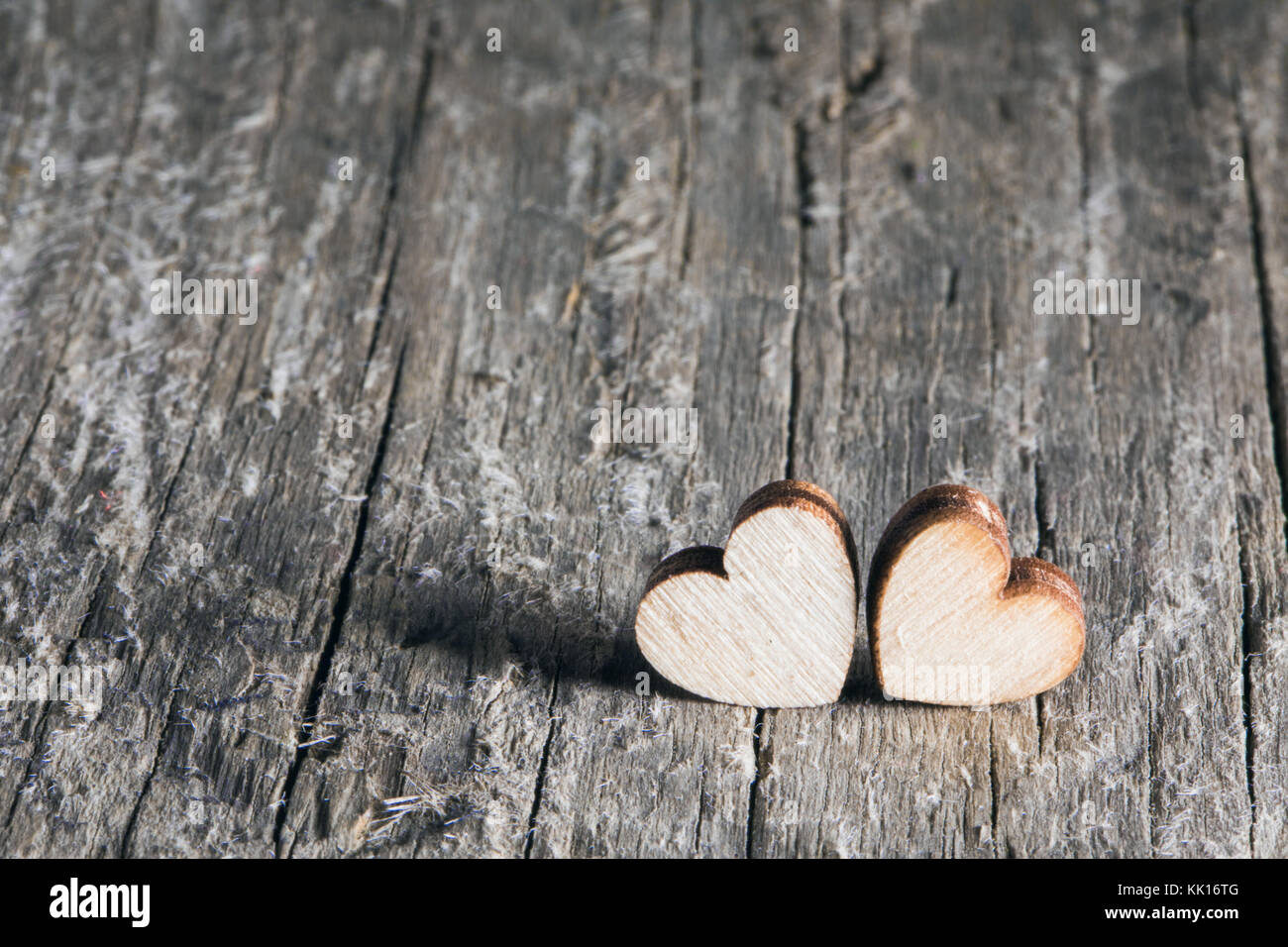 Two small hearts on old wood background Stock Photo - Alamy