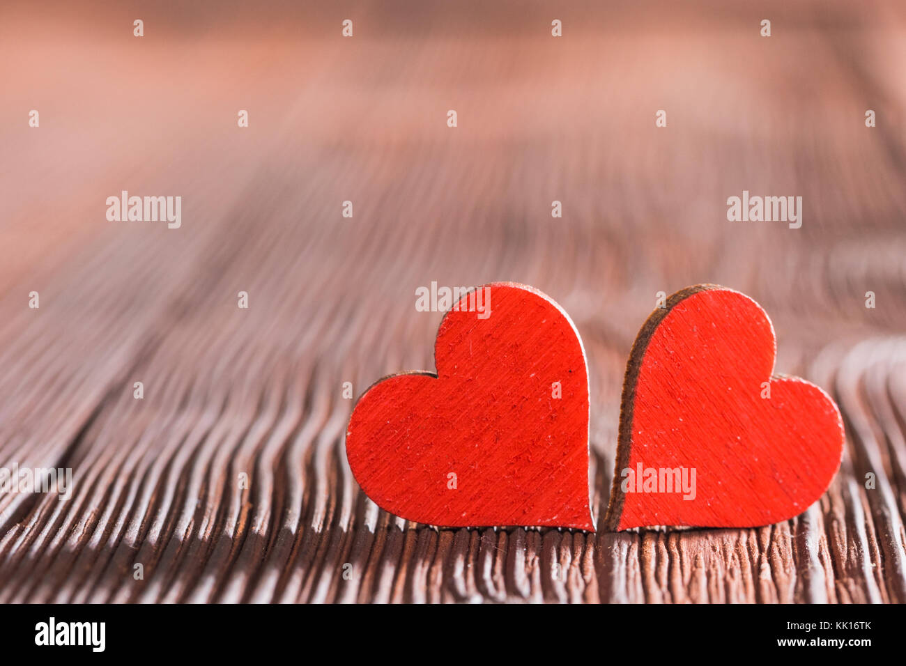 Two small hearts on old wood background Stock Photo - Alamy