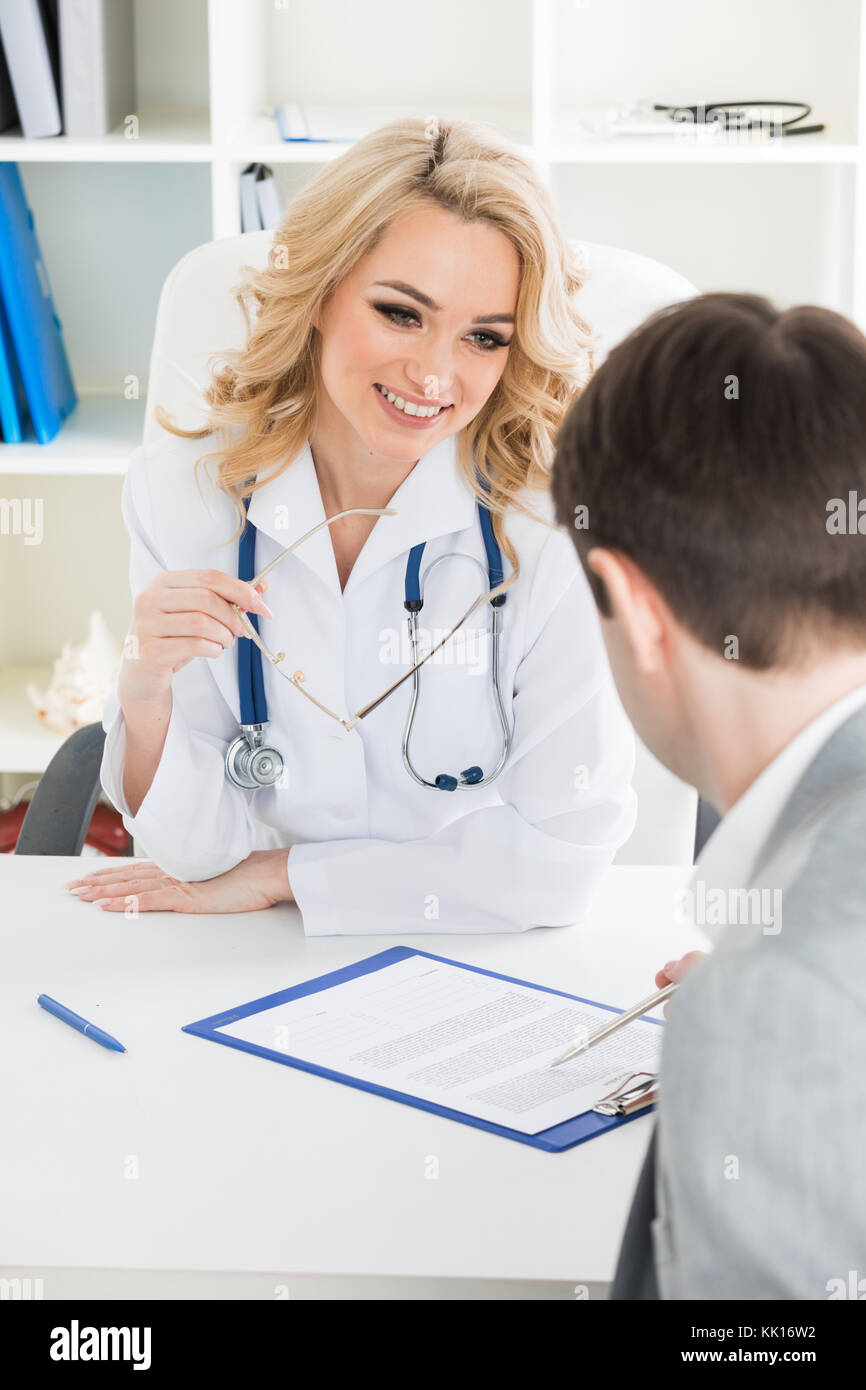 Doctor consulting patient in a clinical office Stock Photo - Alamy