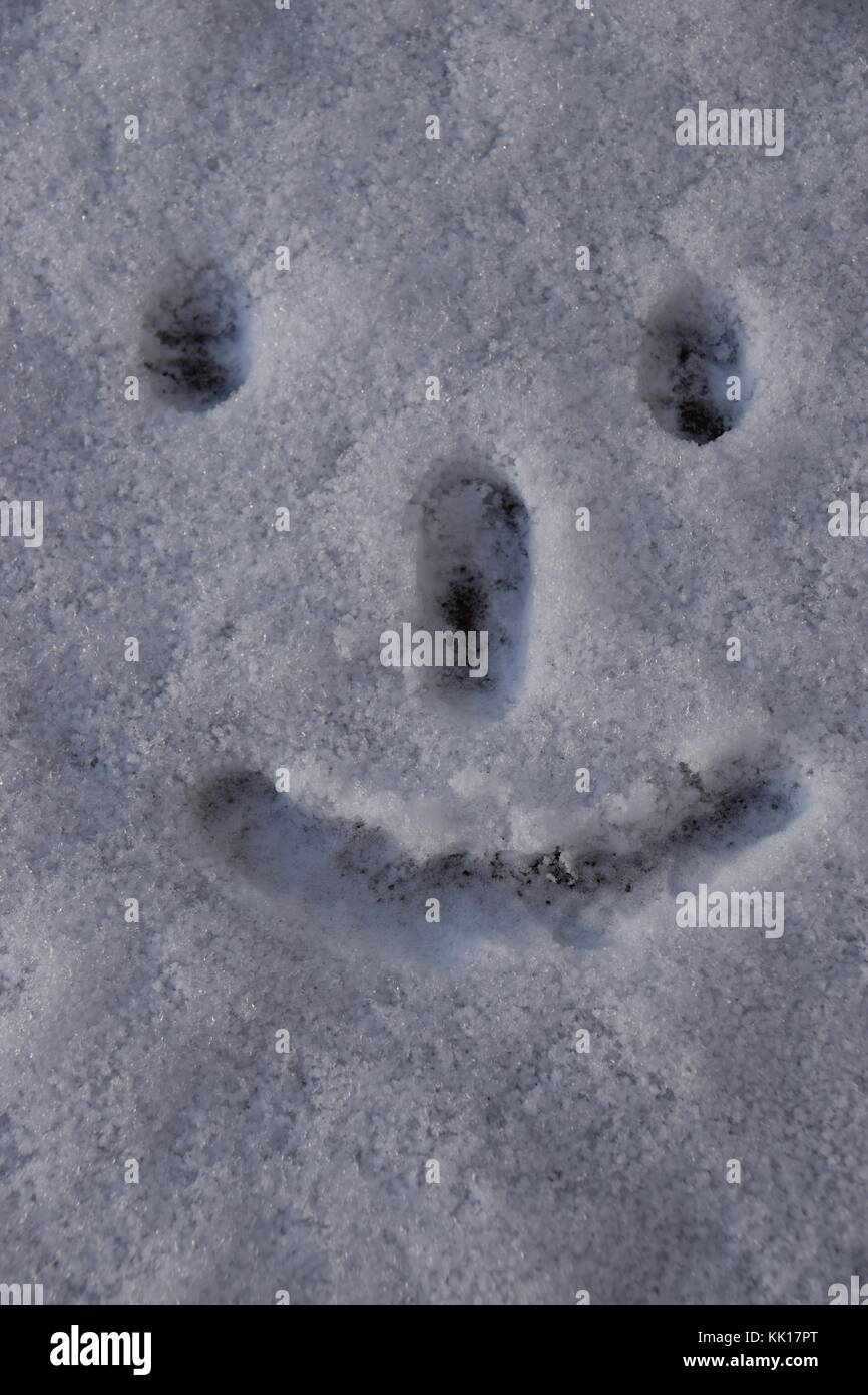 smiley face painted in fresh snow Stock Photo - Alamy
