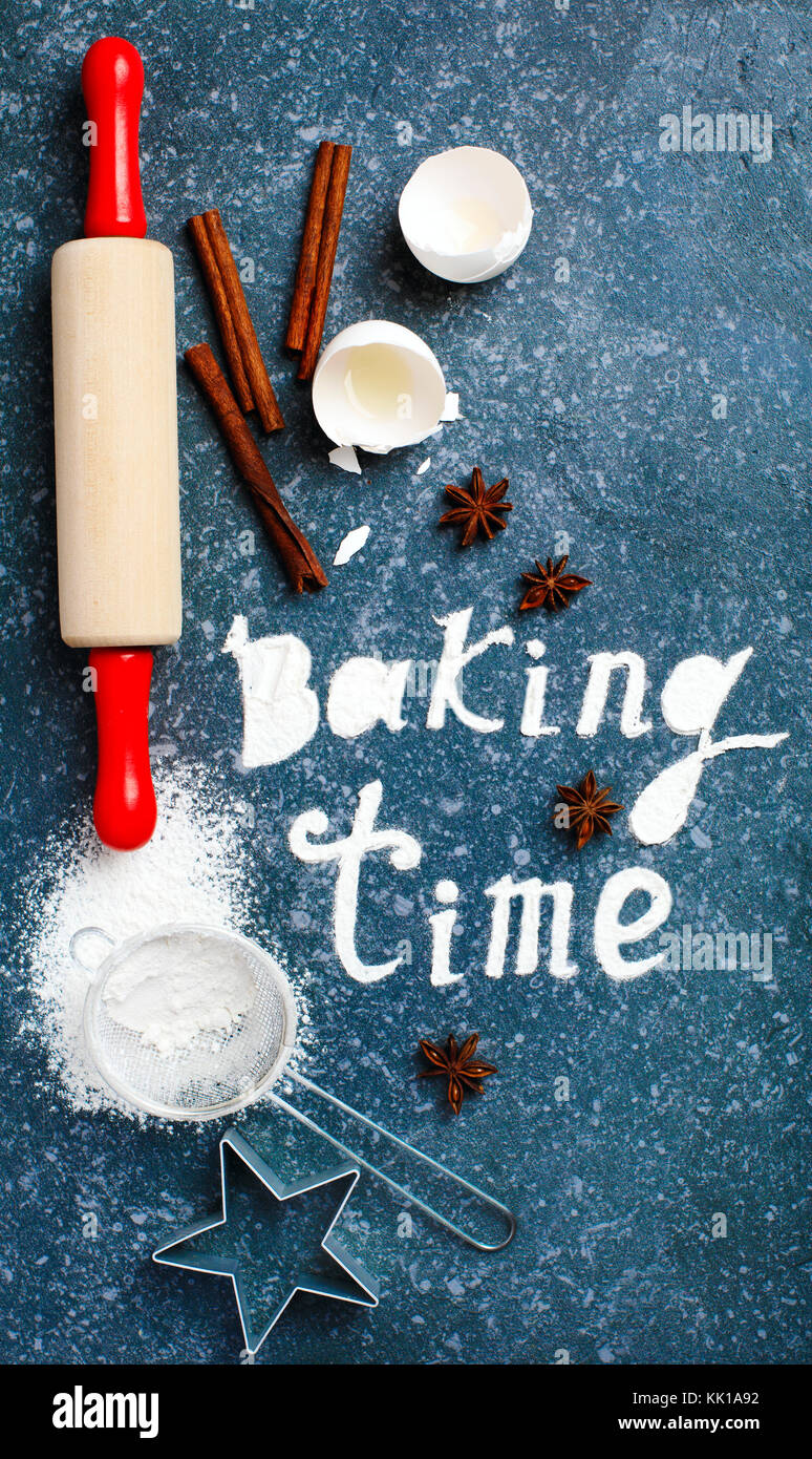 Baking time. Flour sprinkled on the blue table with text baking time ...