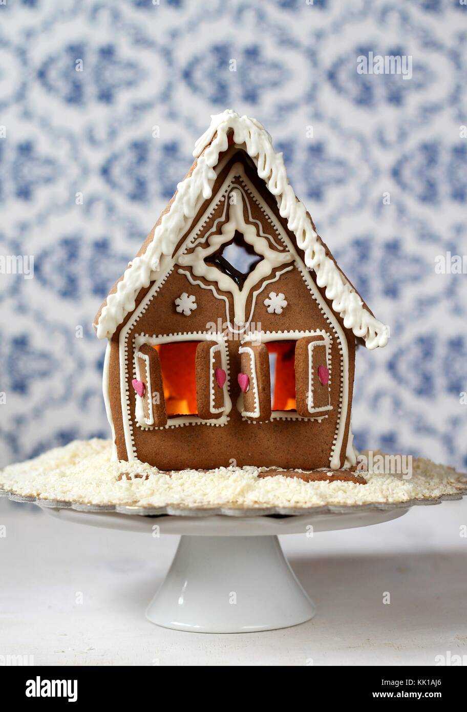 Traditional gingerbread house with lit candle inside Stock Photo - Alamy