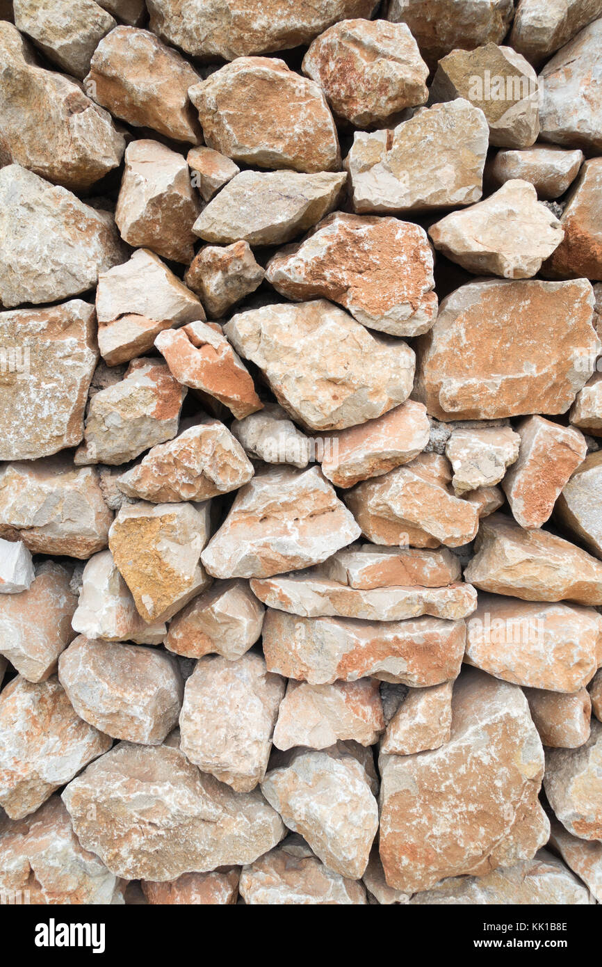 Group of large rocks with a brown orange tint in an open faced wall ...