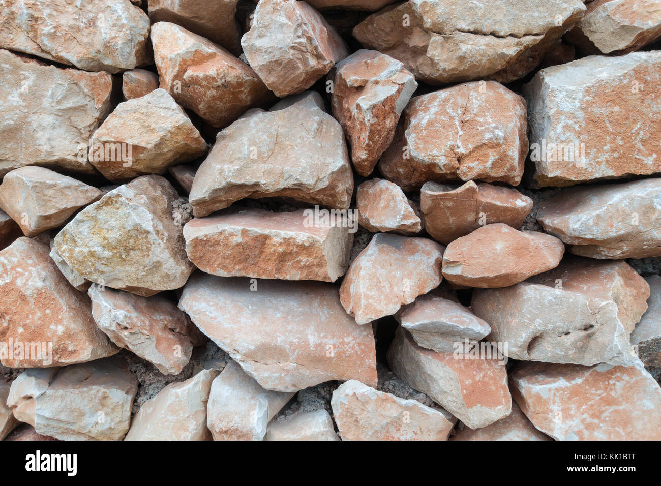 Group of large rocks with a brown orange tint in an open faced wall ...