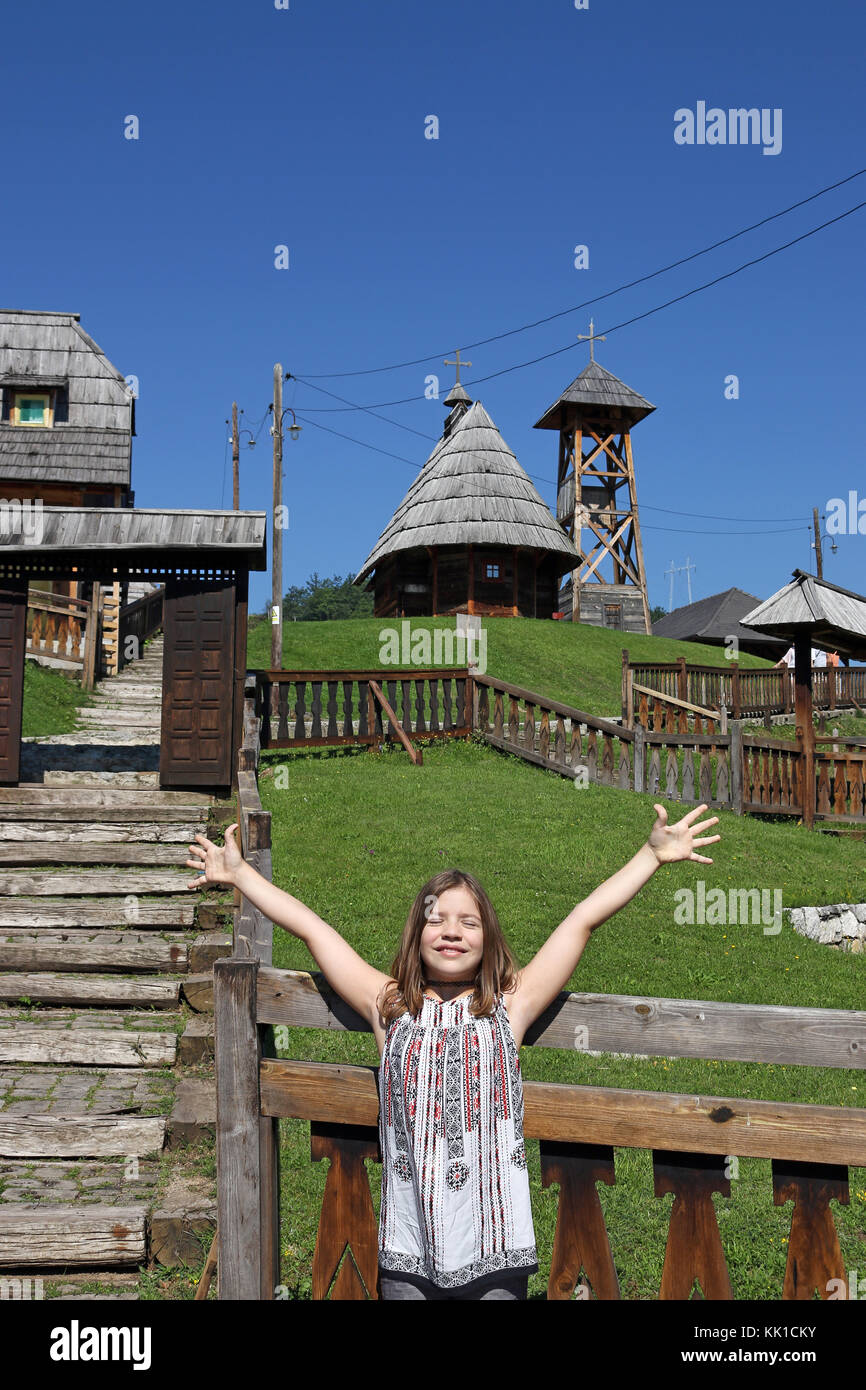 happy little girl with hands up on countryside Stock Photo - Alamy