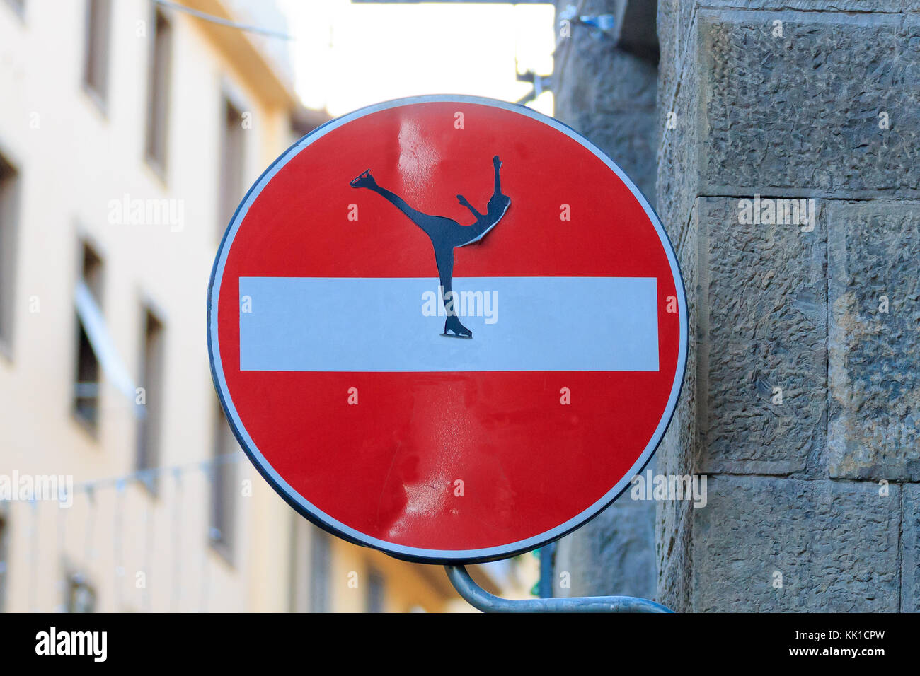 Road sign with a woman that skate on the signal, street art ...