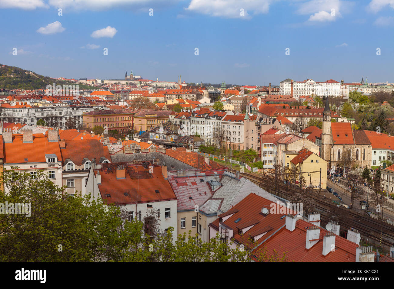 Prague skyline with castle and living blocks red rooftops with park and ...