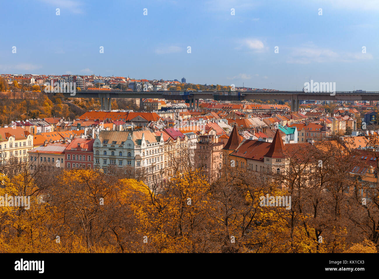Prague living blocks red rooftops with park and trees. Fall season ...