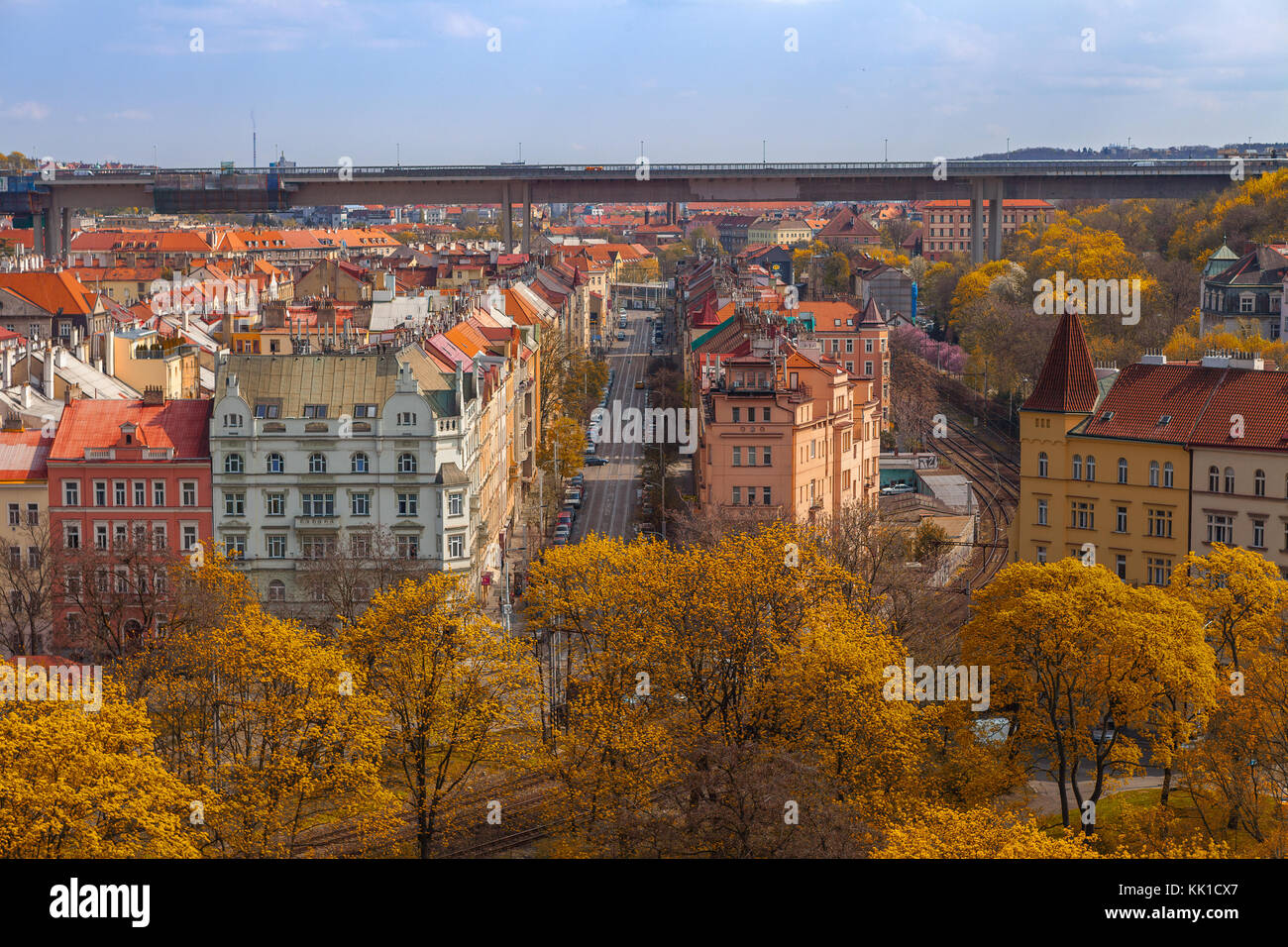 Prague streets with old living blocks red rooftops with park and trees ...