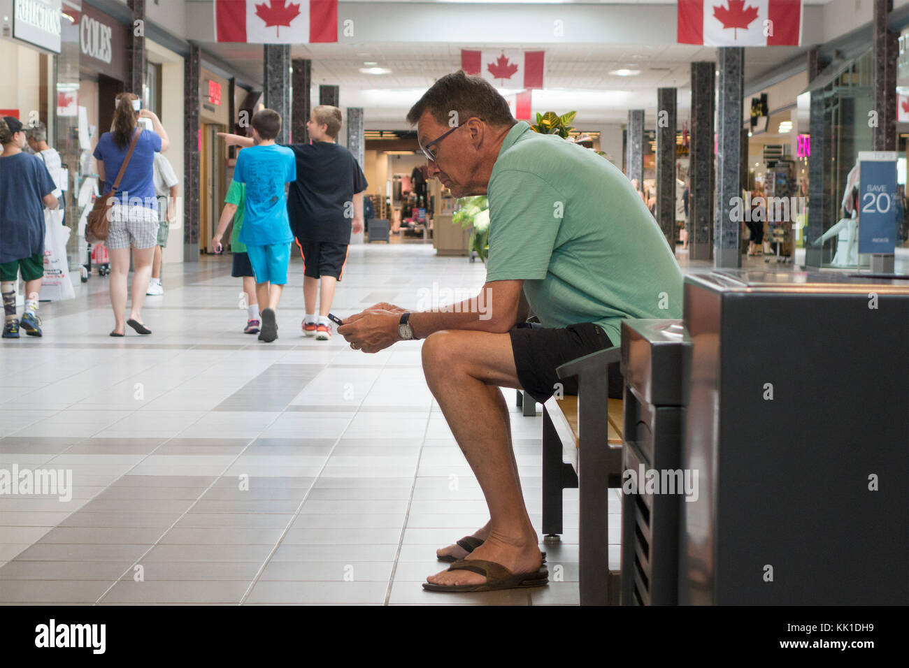 Sitting man checking phone hi-res stock photography and images - Alamy