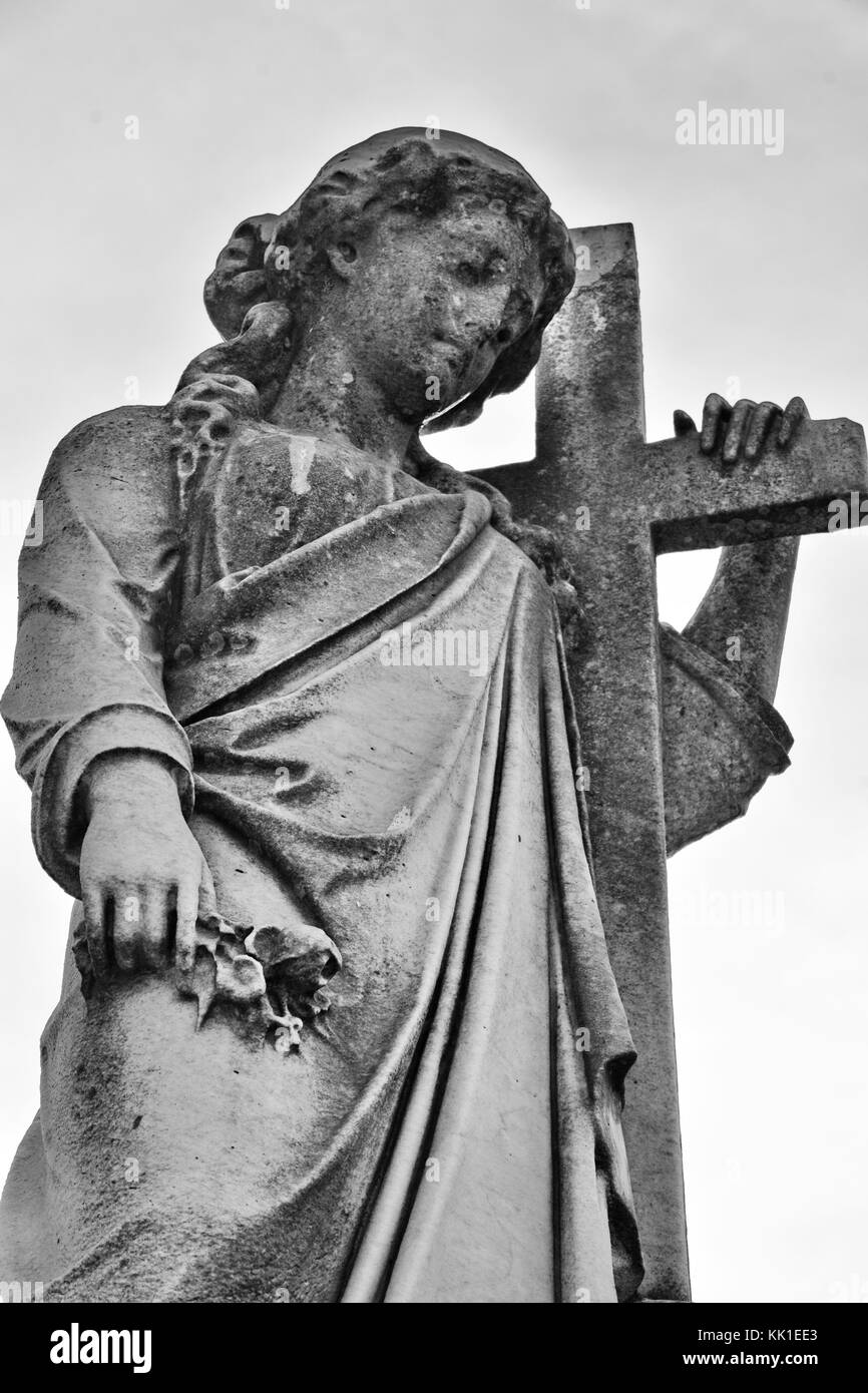 A beautiful lady bears a cross and a small bouquet of flowers Stock ...