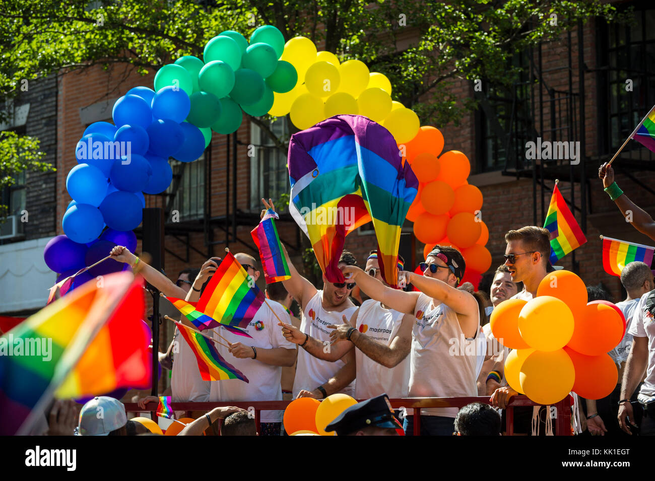 NEW YORK CITY - JUNE 25, 2017: Participants wave rainbow flags on a ...