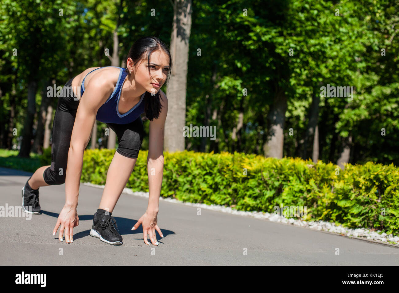 sportive teen starting running in the park Stock Photo - Alamy