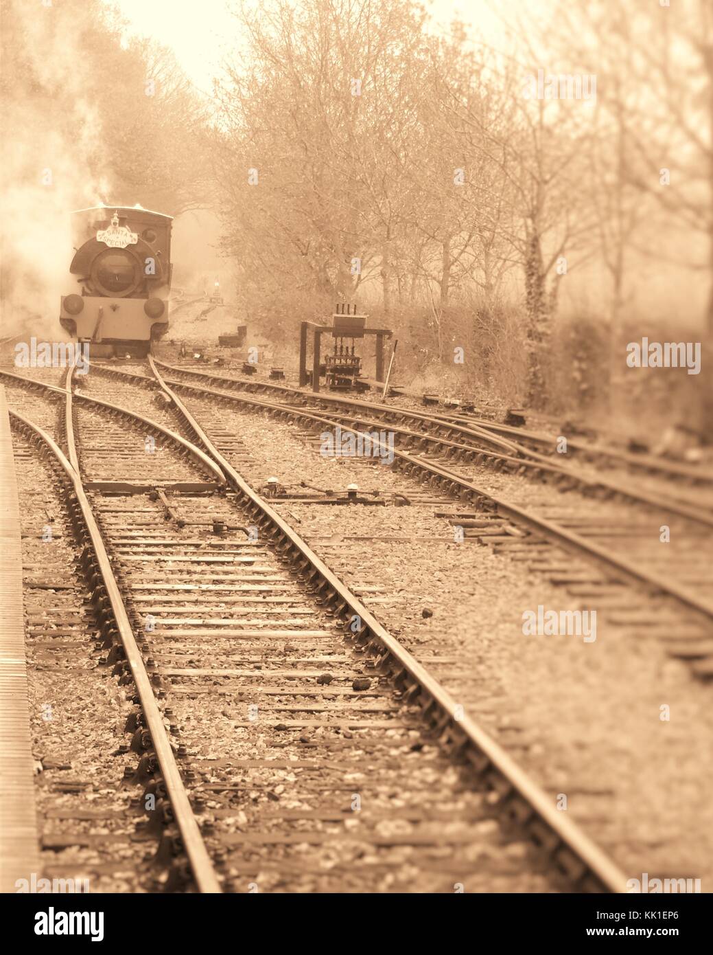 steam engine approaching station along tracks Stock Photo - Alamy