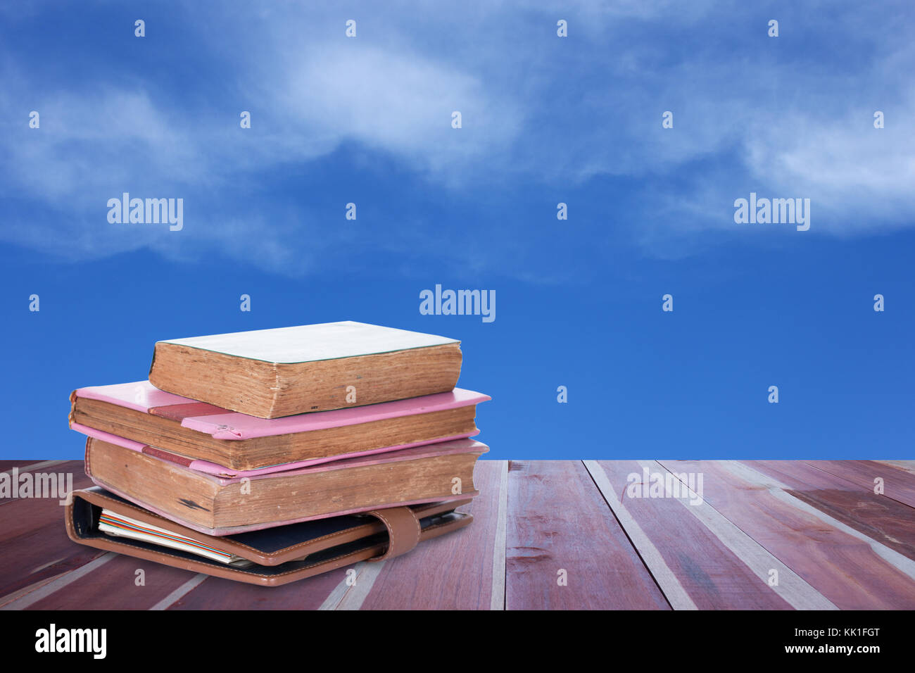 Old books on wooden planks with blue sky Stock Photo - Alamy