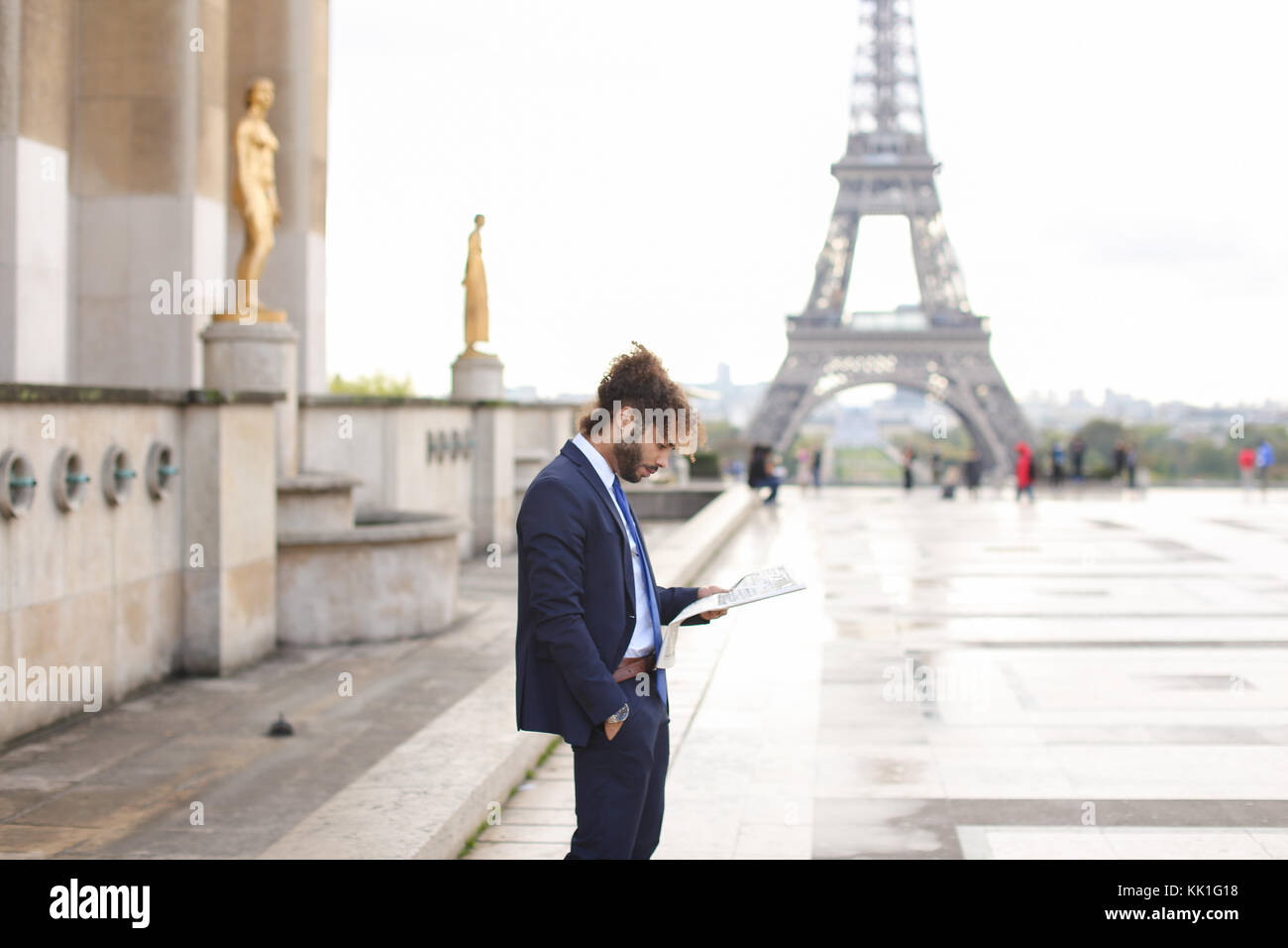 Hispanic journalist close to Eiffel Tower reading newspaper and Stock ...