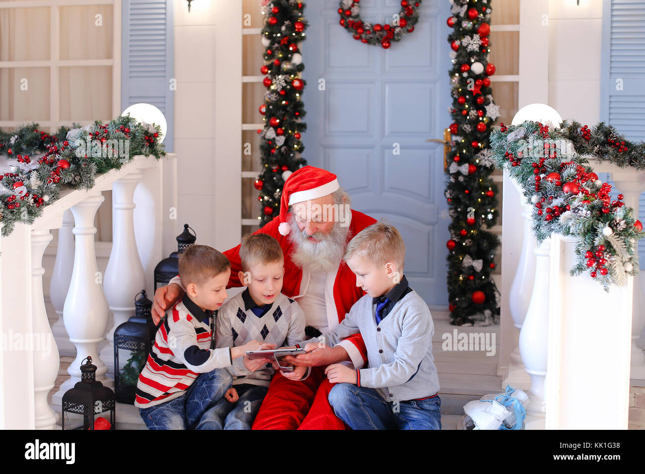 Happy children playing with Santa Claus Stock Photo - Alamy