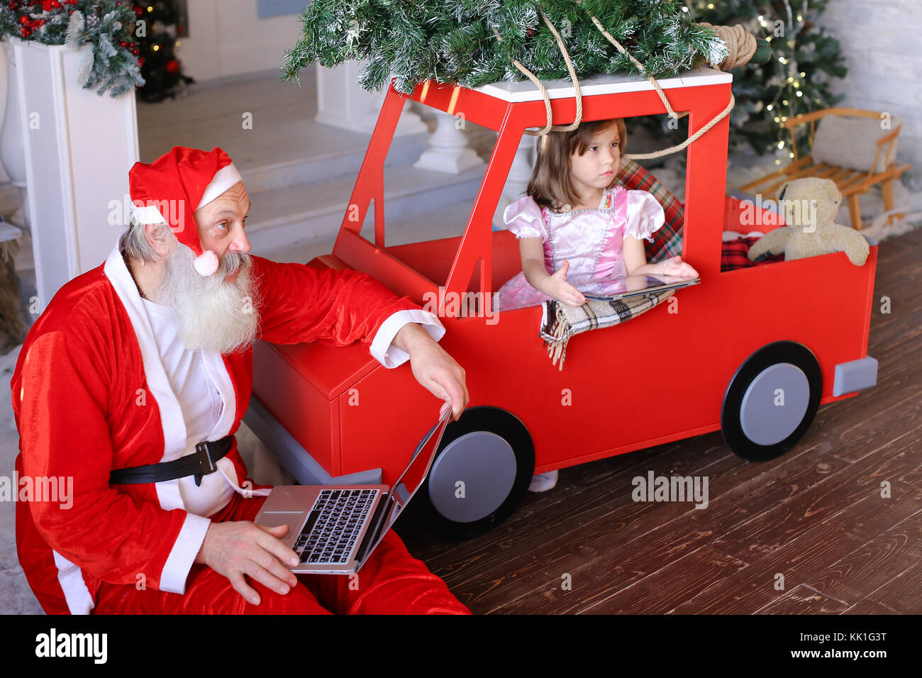 Funny Father Christmas doing thumbs up near gladden little princ Stock ...