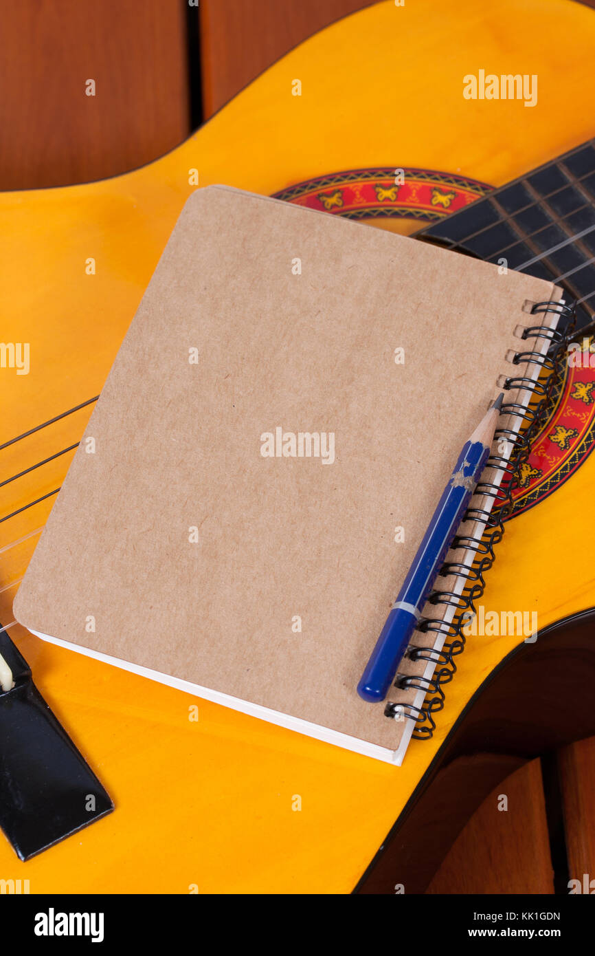 Diary and a used pencil on classical guitar background Stock Photo - Alamy