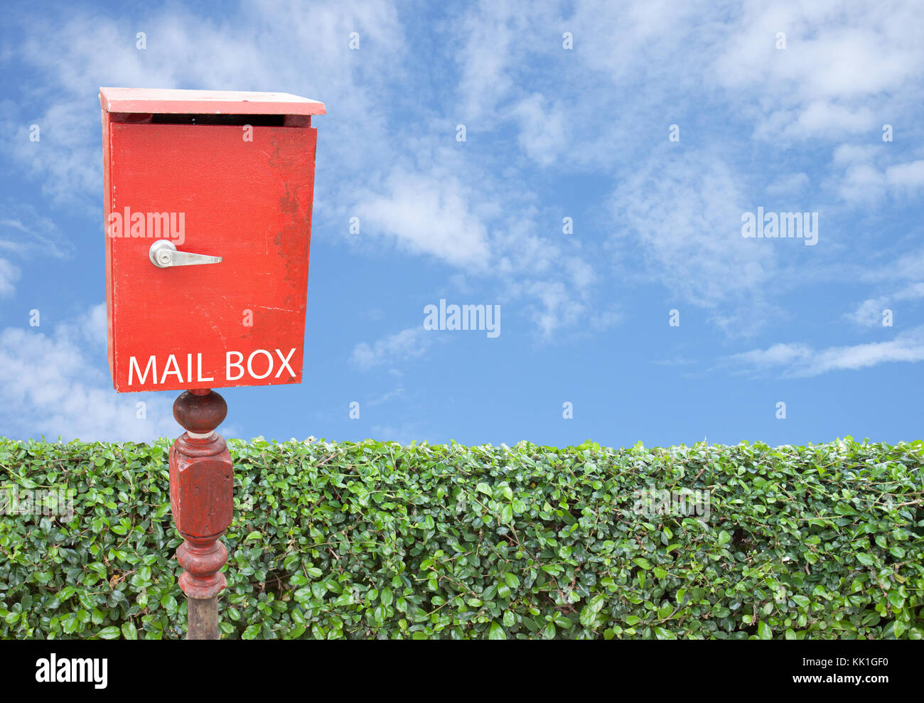 Red mail box with blue sky background Stock Photo - Alamy