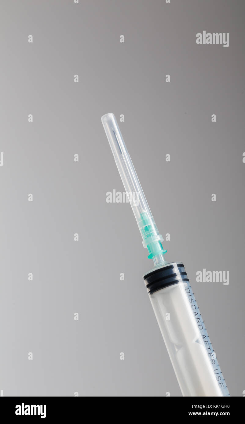 Close up macro view of a syringe / syringes full of coloured fluid ...