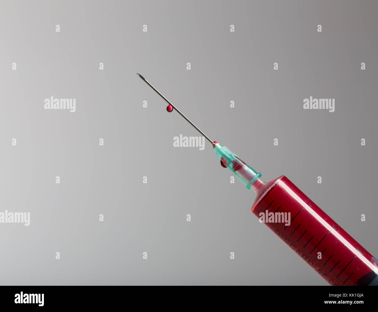 Close up macro view of a syringe / syringes full of coloured fluid ...