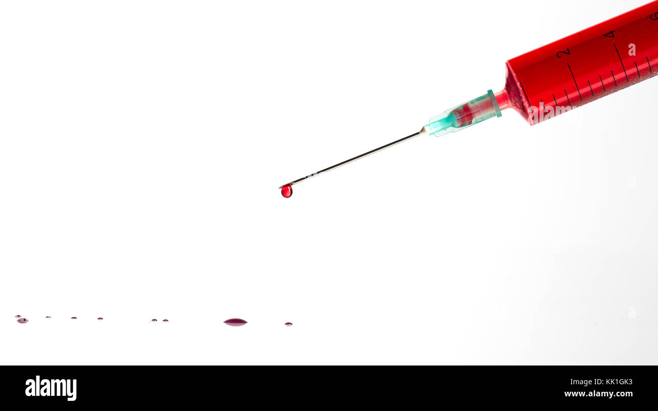 Close up macro view of a syringe / syringes full of coloured fluid ...