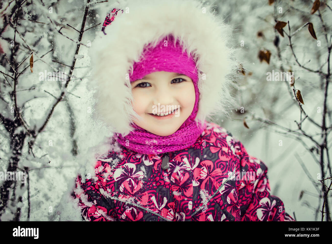 cute kid smiling in winter park Stock Photo - Alamy