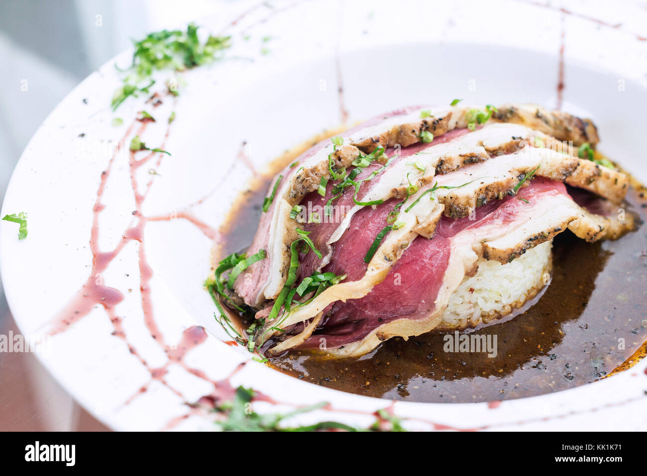 Roast beef modern fusion gourmet food cuisine meal with gravy Stock ...