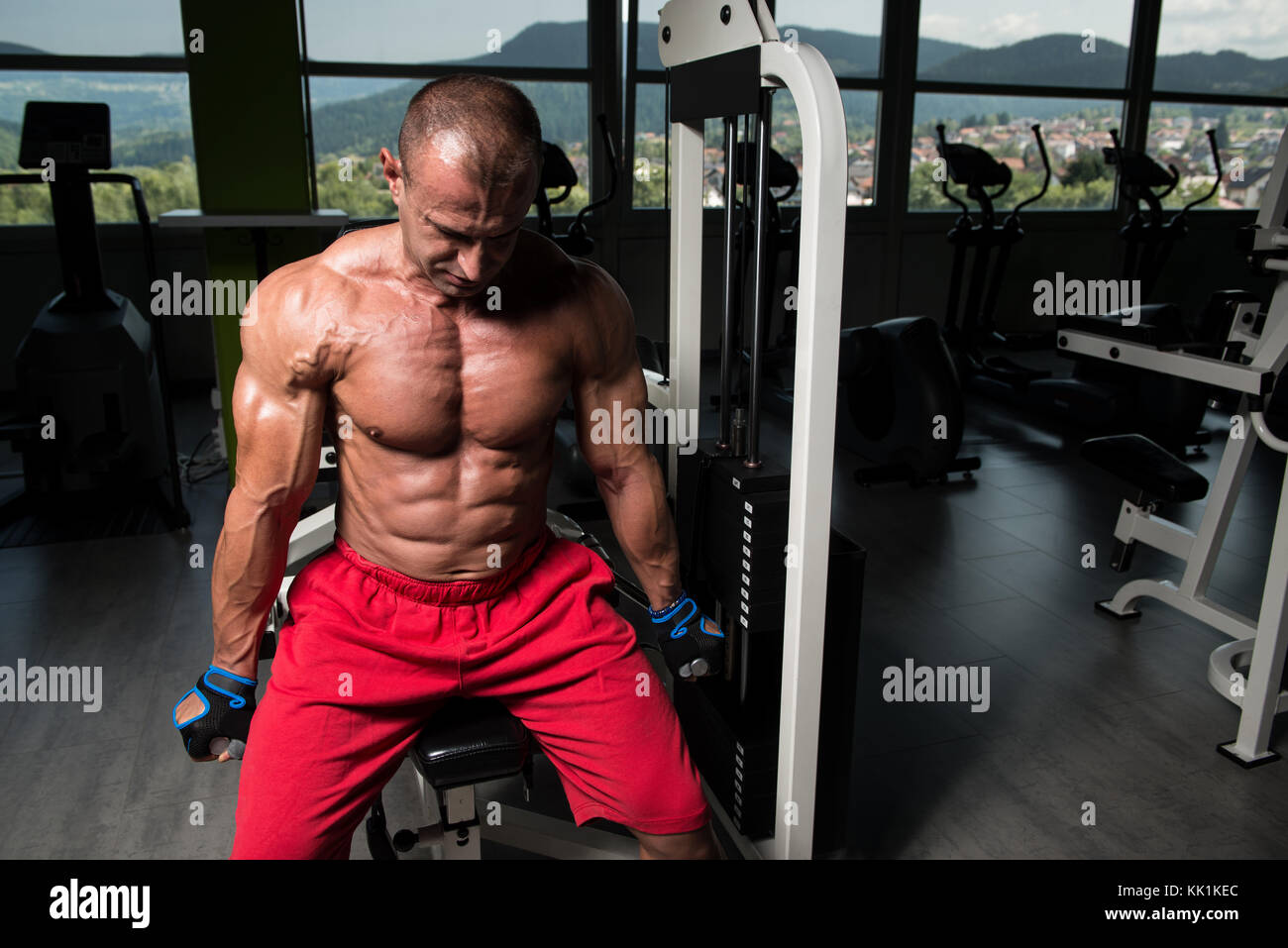 Man Doing Heavy Weight Exercise For Trapezius On Machine Stock Photo ...