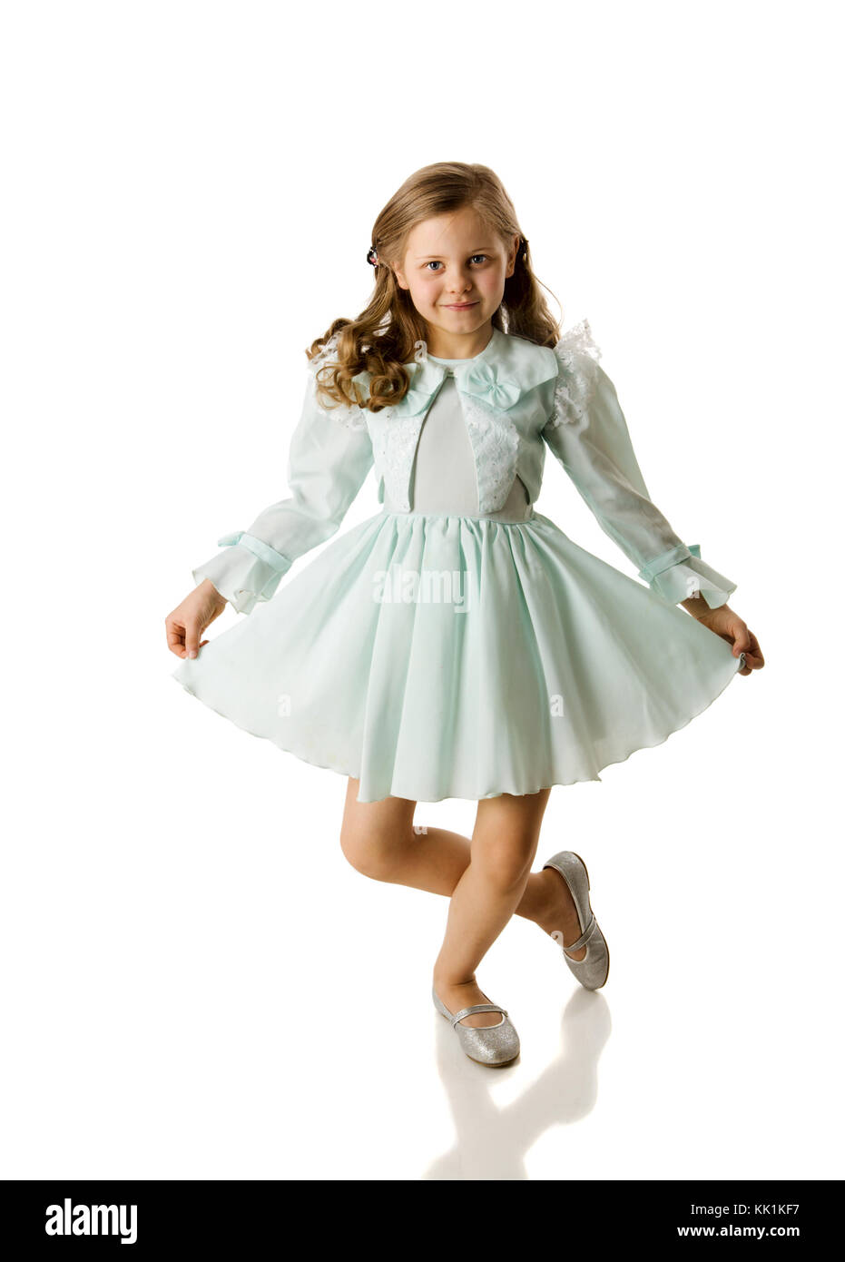 Cheerful girl spinning on floor isolated on white Stock Photo - Alamy