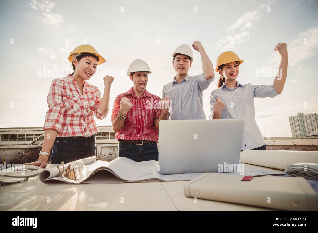 Happy professional construction engineers working in congratulation ...