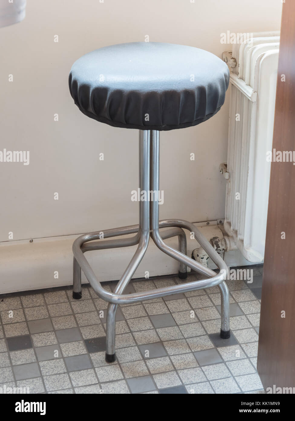 Old metal stool standing in the corner Stock Photo - Alamy