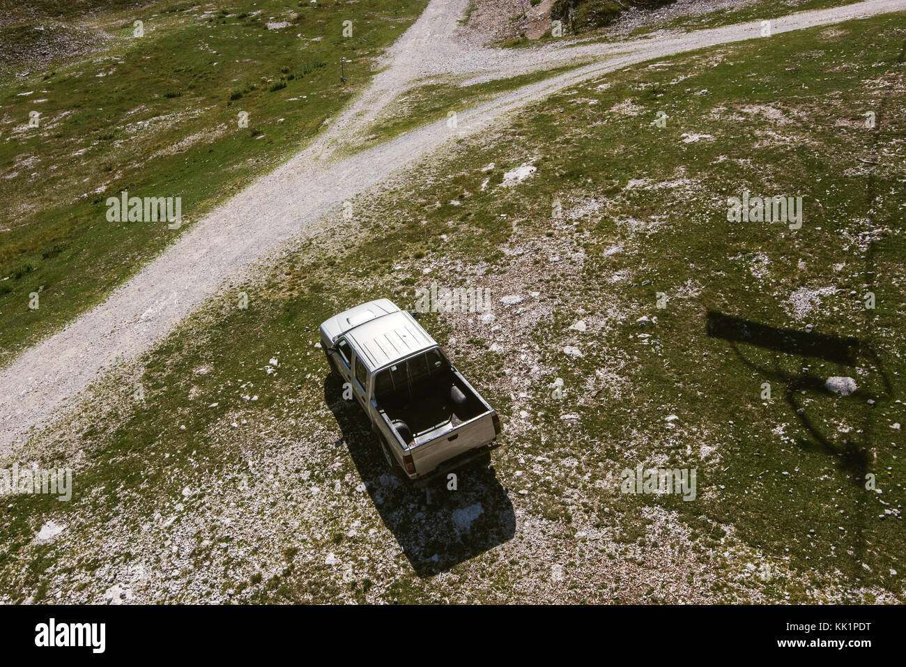 Pick up truck on mountain road, aerial view of the vehicle Stock Photo ...