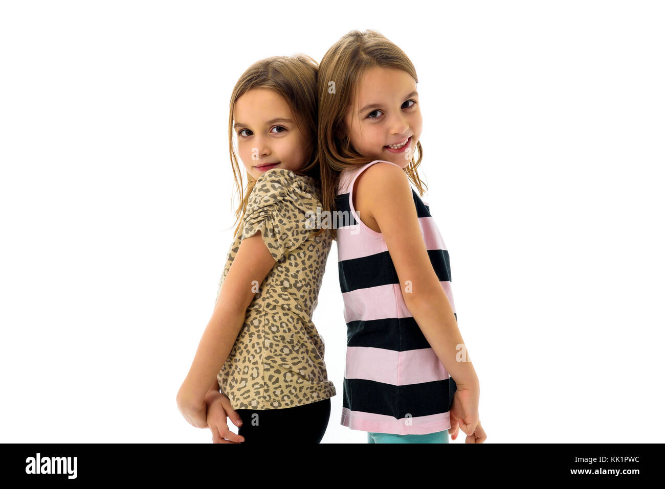 Identical twin girls are turned facing back to back. Concept of family ...