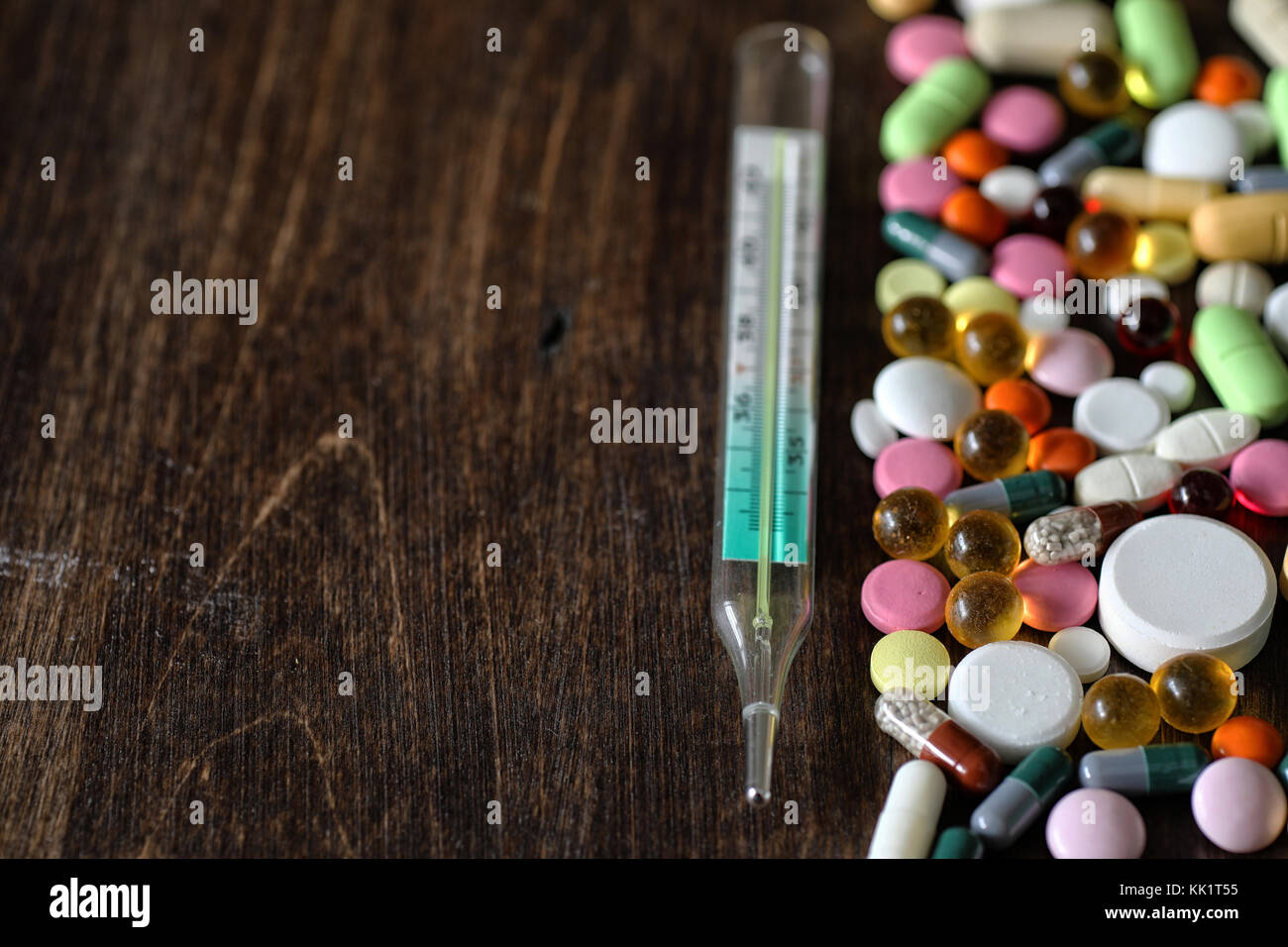 Medical background of various colorful medications on a textured wooden ...
