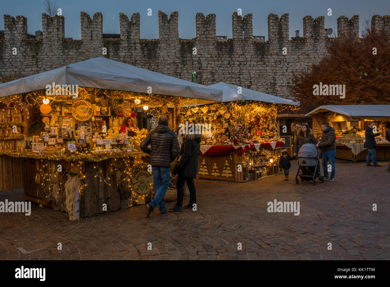 The colorful christmas market in Trento city in the evening. Trentino ...