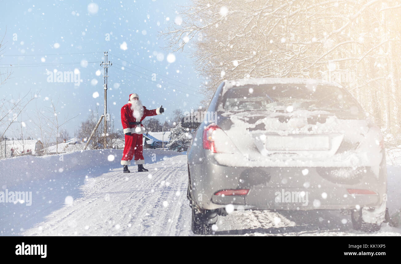 Santa Claus comes with gifts from the outdoor. Santa in a red su Stock ...