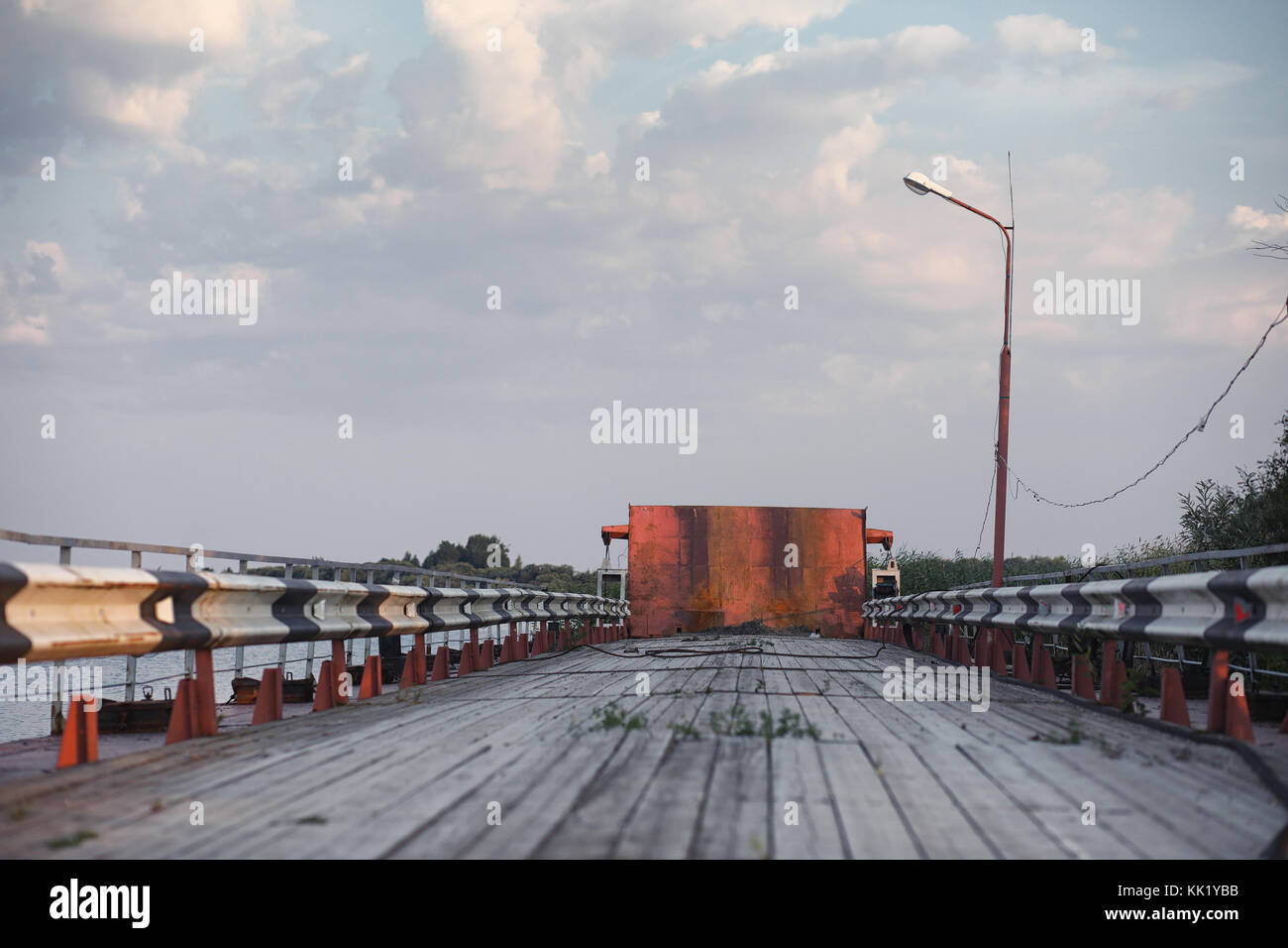 Wooden bridge on the river bank. A wooden road with pillars. Pan Stock ...