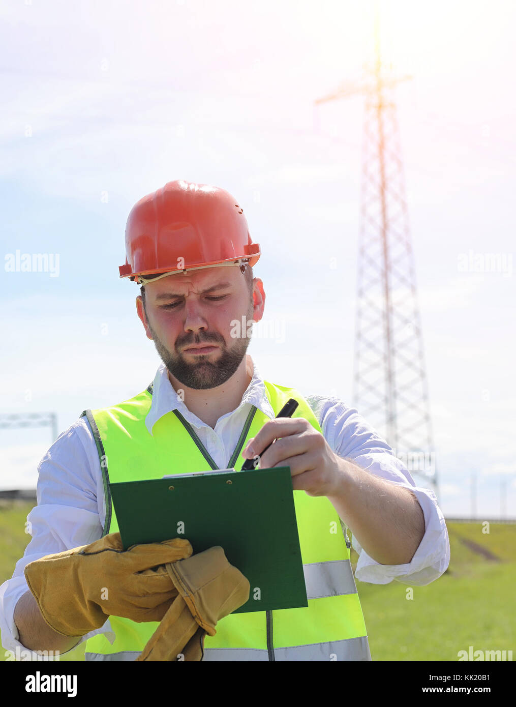 An electrician in the fields near the power transmission line. T Stock ...