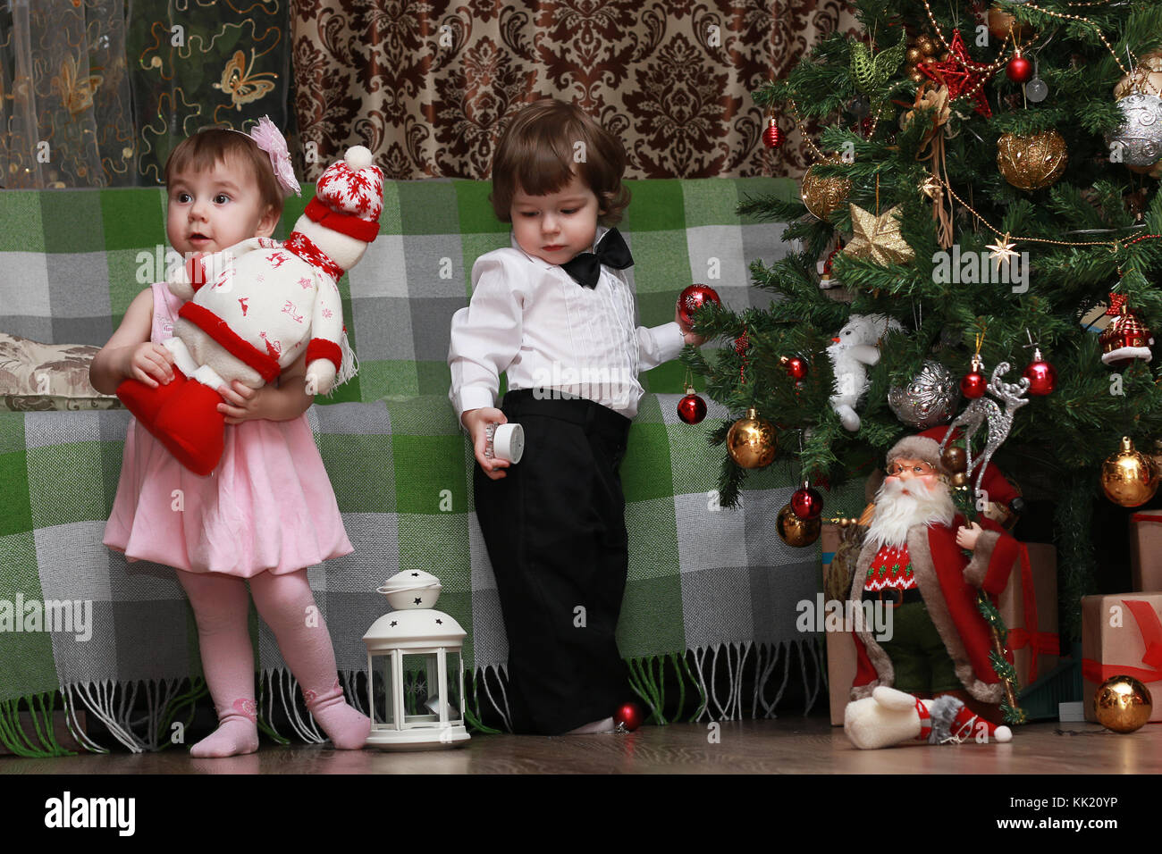 Little children near a Christmas Stock Photo - Alamy