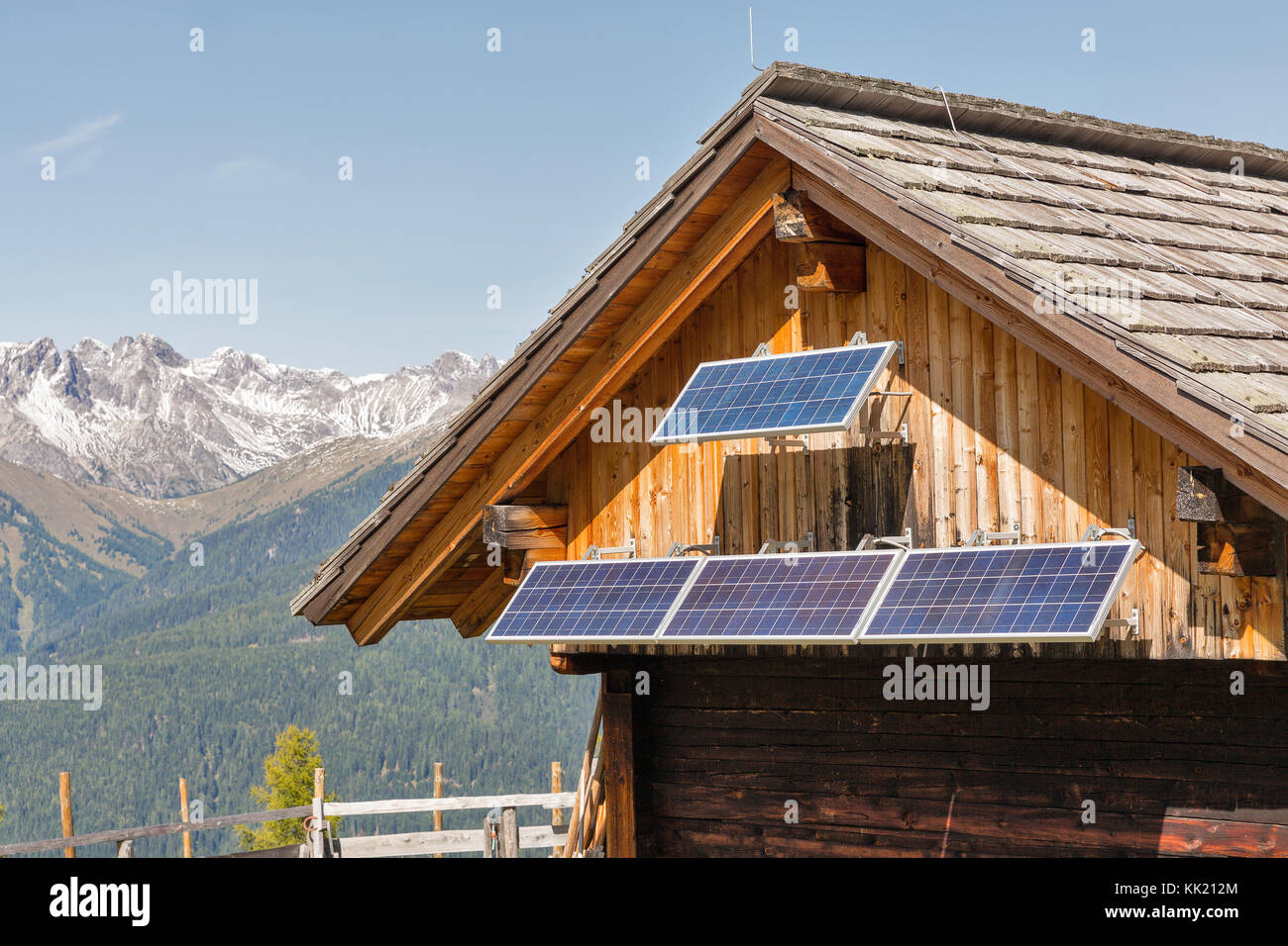Wooden shepherd lodge with solar panels with Alpine mountain landscape ...